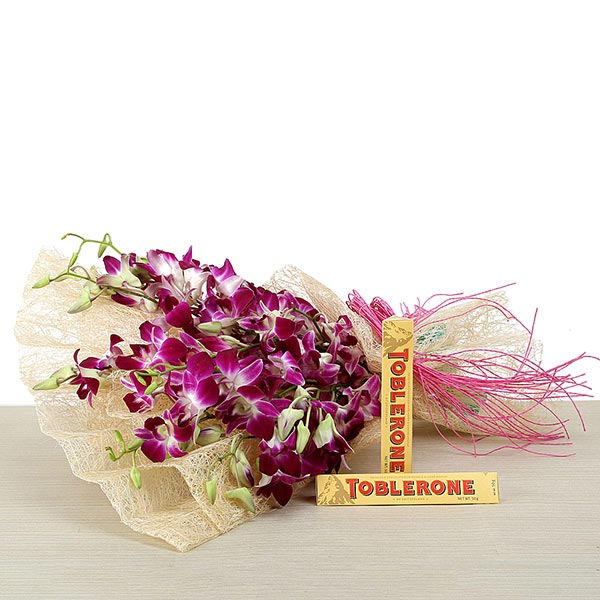 Send Purple Orchids in Jute Wrapping N Toblerone Chocolates Online ...